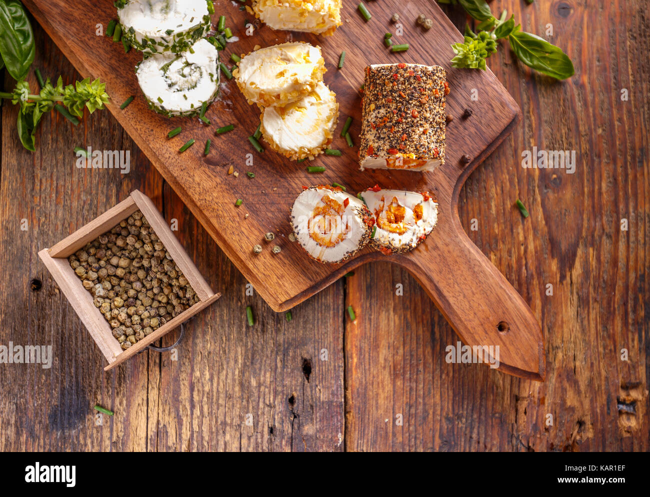 Top view of spicy cheeses on wooden cutting board Stock Photo - Alamy