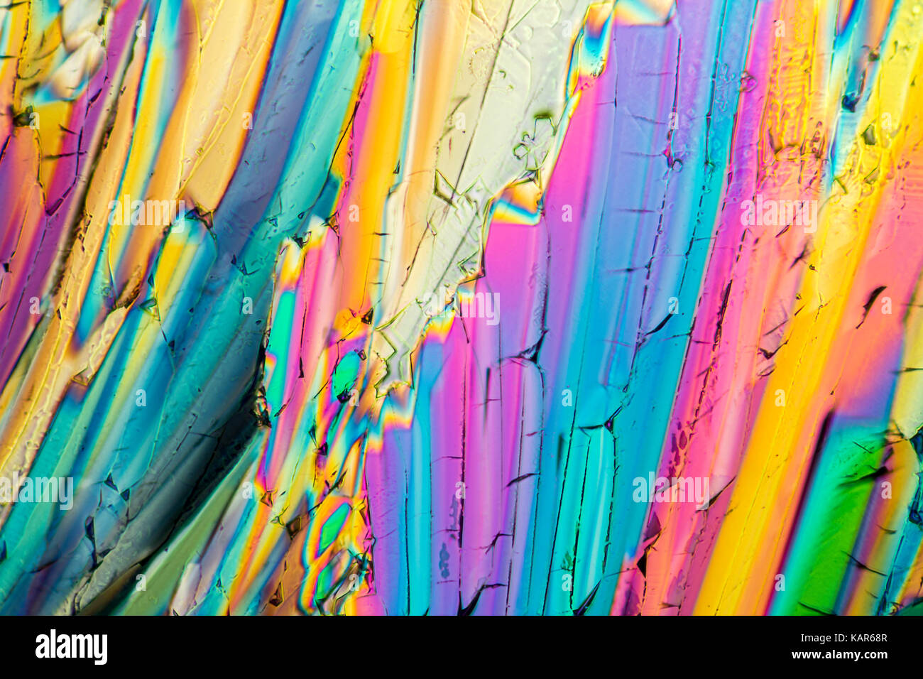 colorful microscopic shot of sugar micro crystals in polarized light ...
