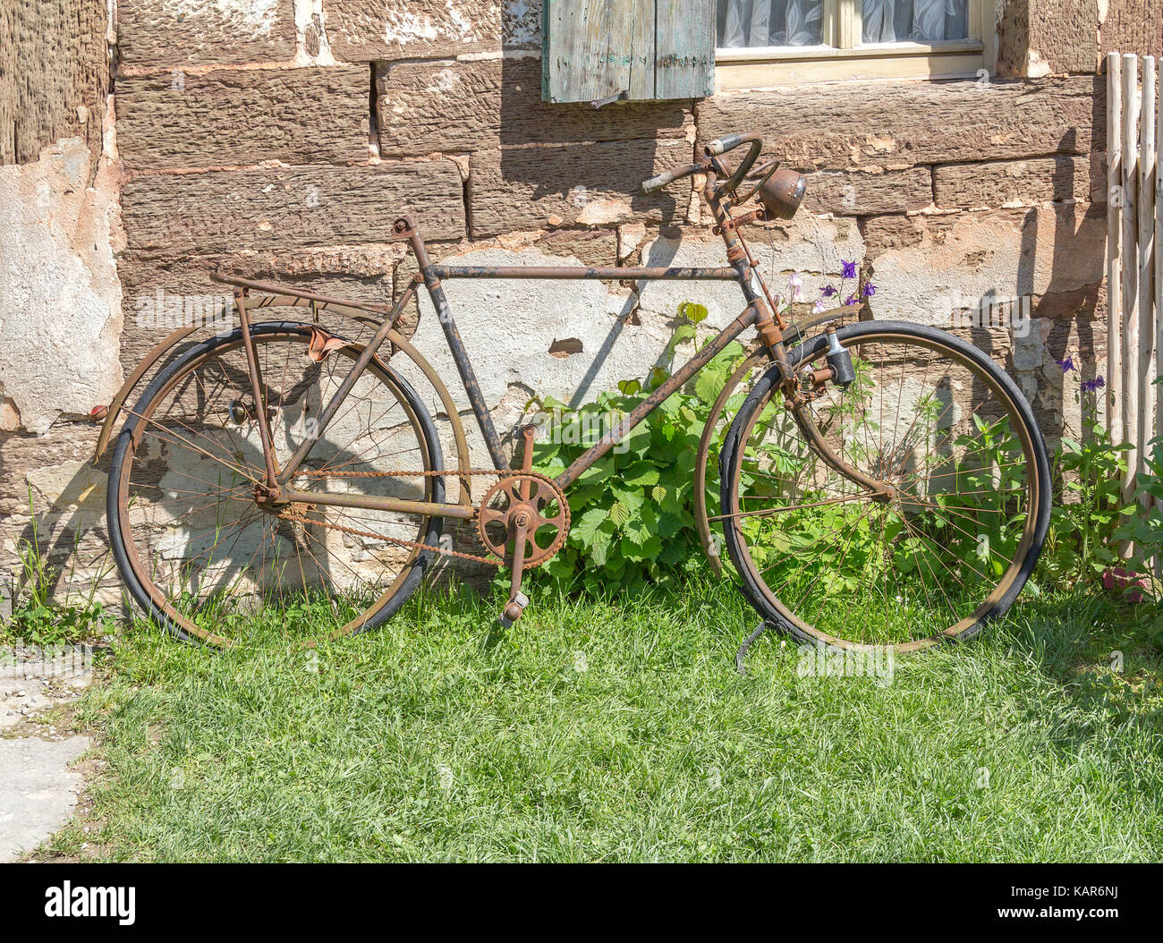 rundown house facade and rotten bicycle in sunny ambiance Stock Photo ...