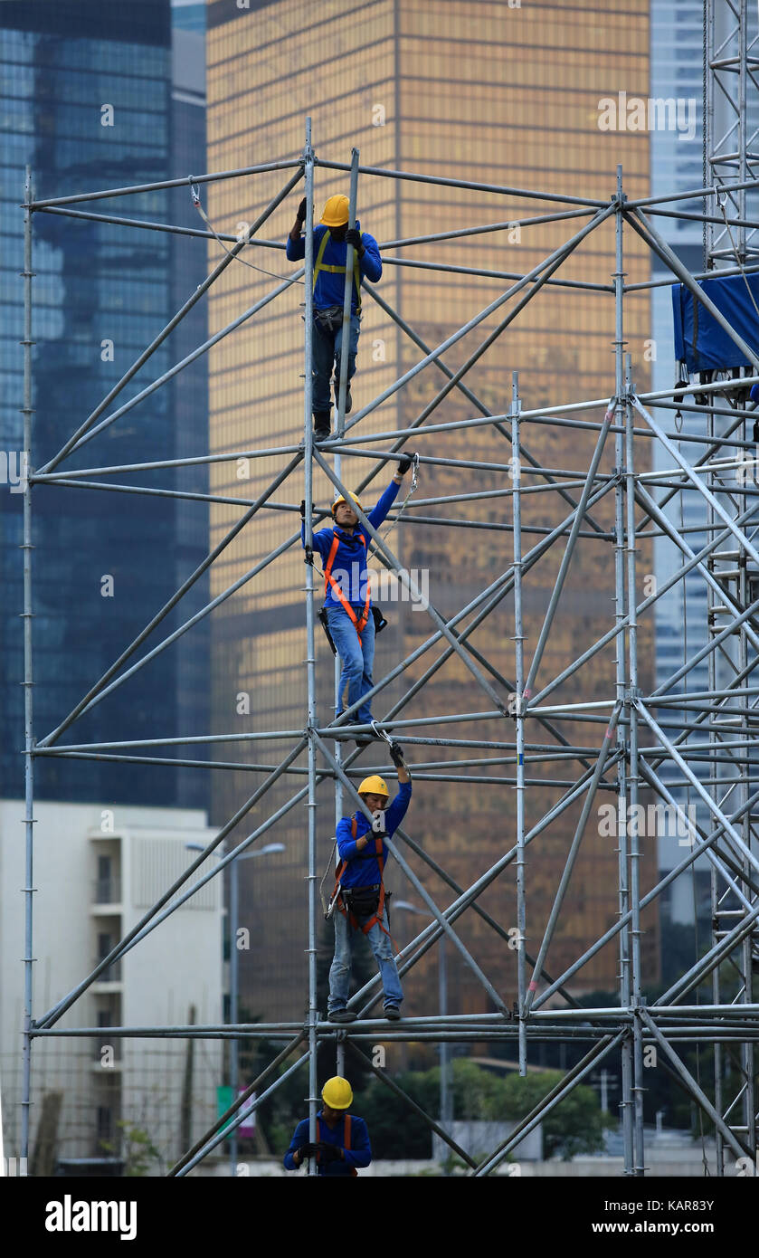 Construction workers stand on scaffolding hi-res stock photography and ...