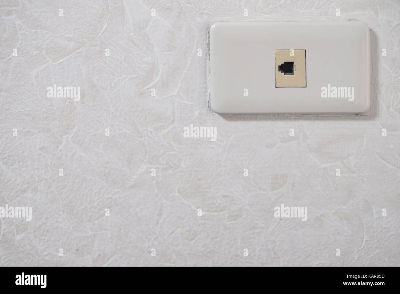 Old socket for internet cable, telephone port wall socket on white wall ...