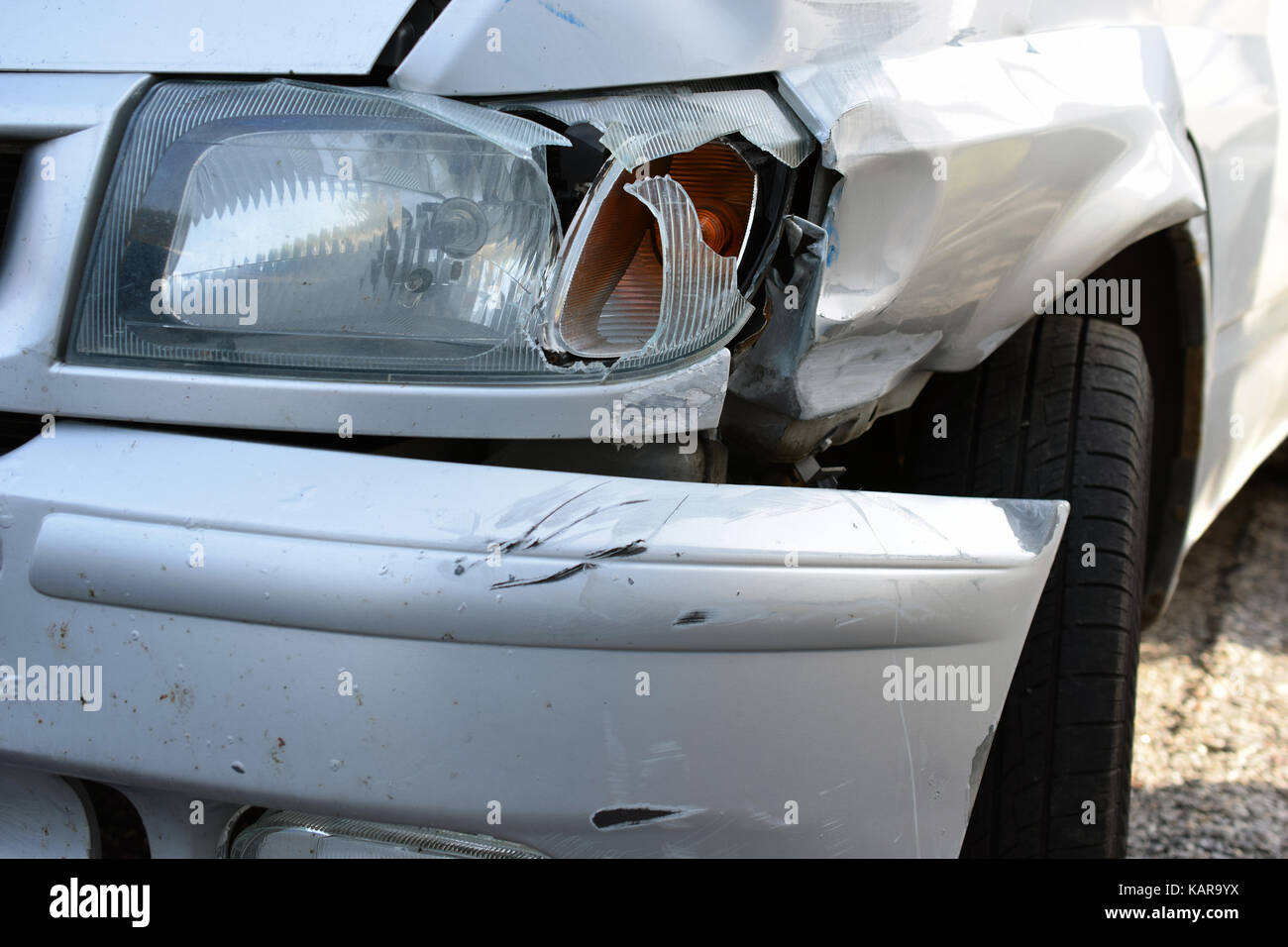 Front view of damaged silver car after accident Stock Photo - Alamy