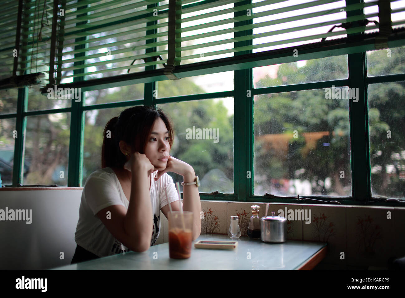 Girl look at watch, waiting someone who late with no patience in cafe ...