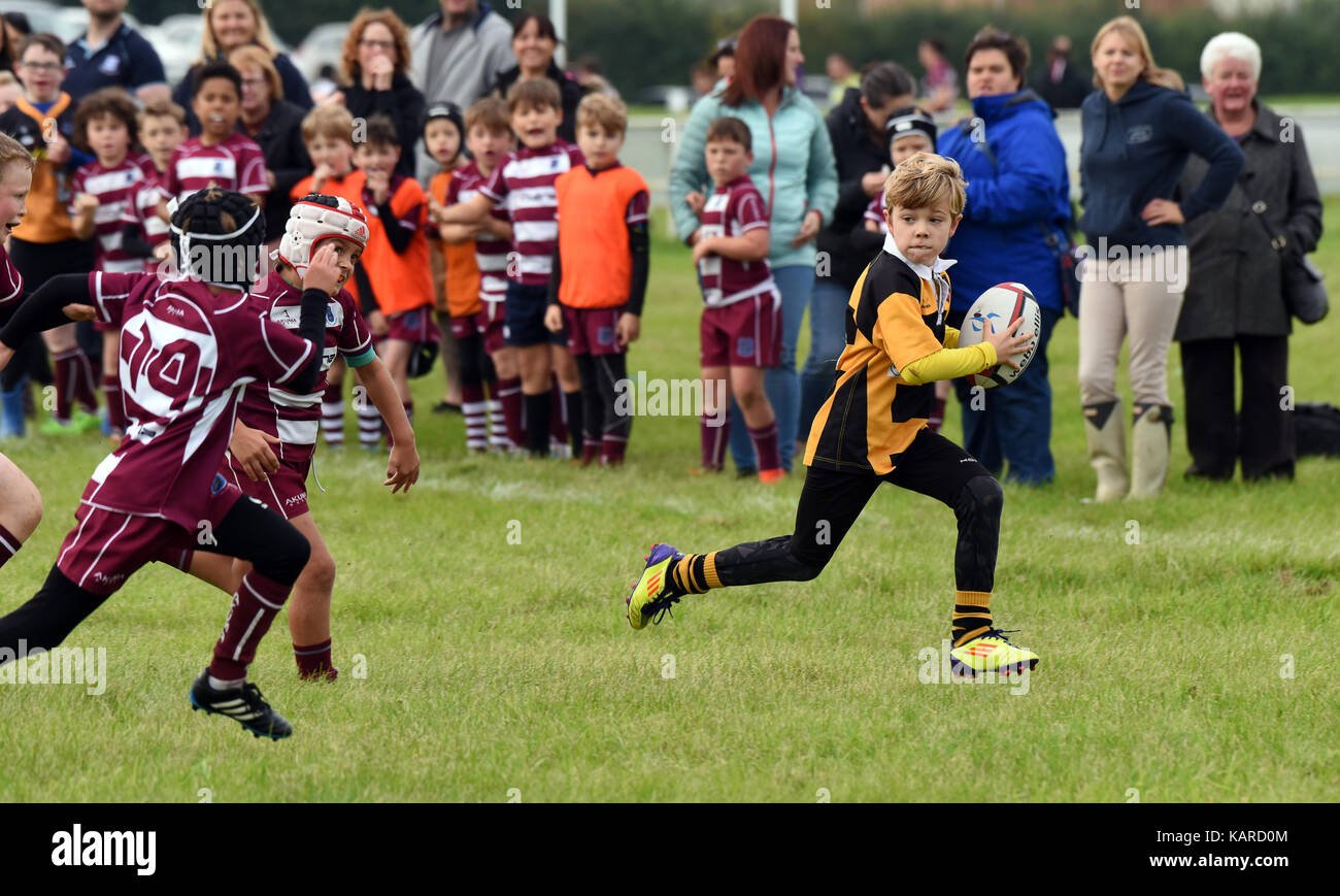 Boys playing junior rugby watched by parents Britain Uk Stock Photo - Alamy