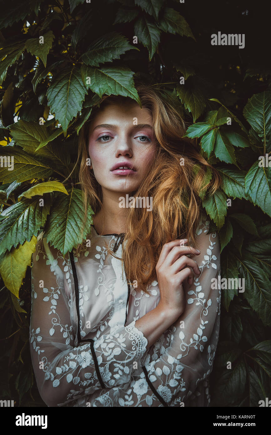 stylish hipster woman with fern leaf embracing. girl portrait with ... stylish hipster woman with fern leaf embracing. girl portrait with ...