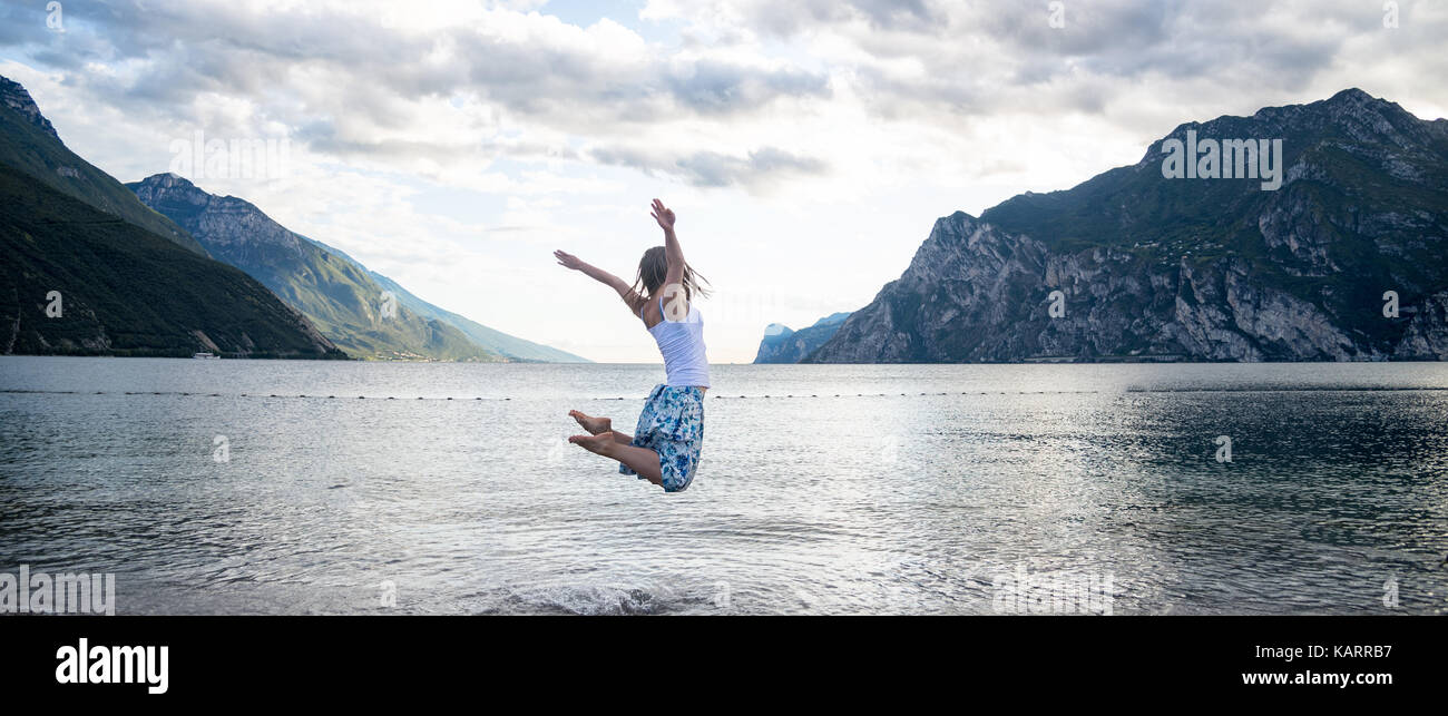 Woman jumping at the lake Garda. Italy Stock Photo - Alamy
