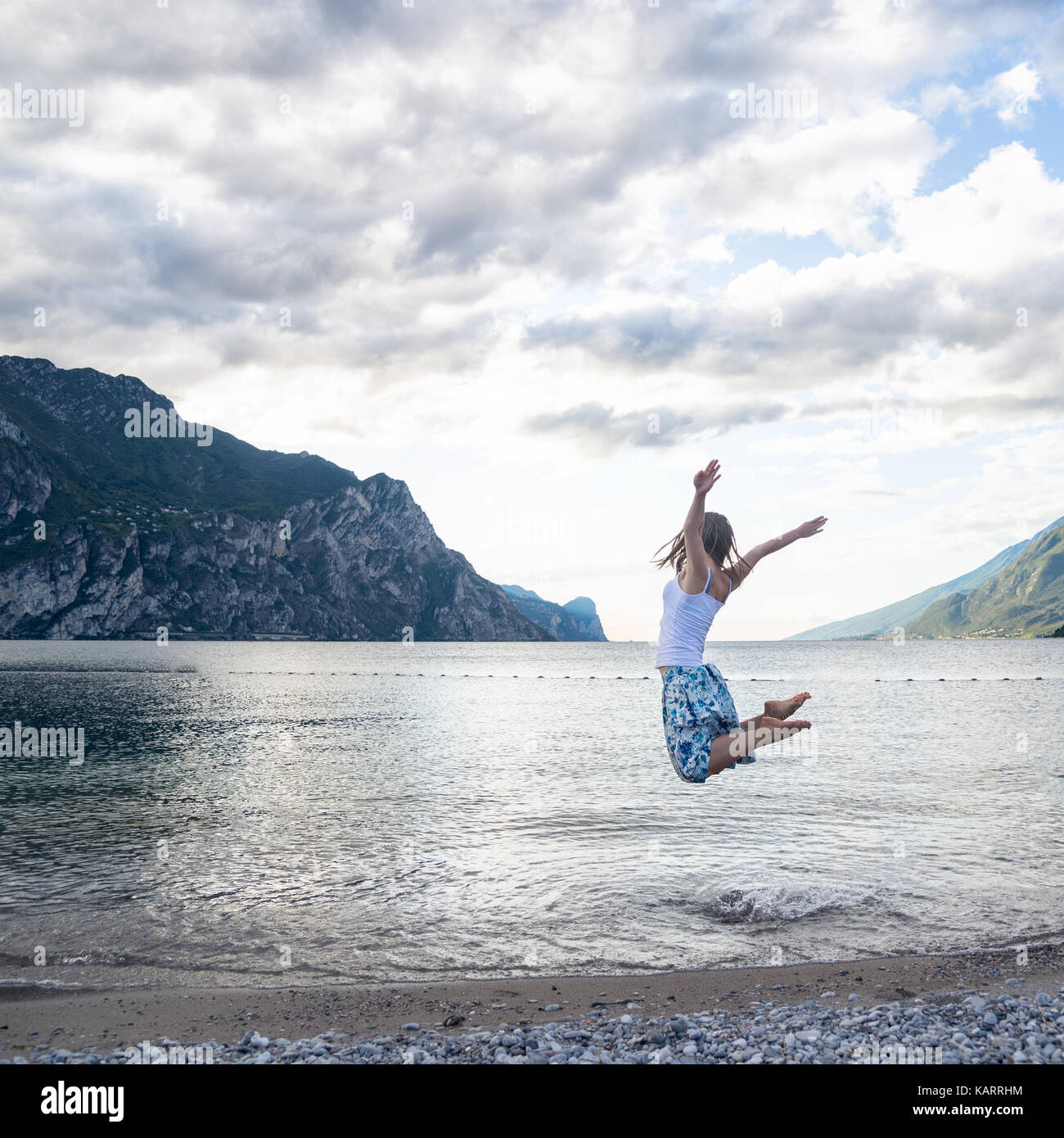 Woman jumping at the lake Garda. Italy Stock Photo - Alamy