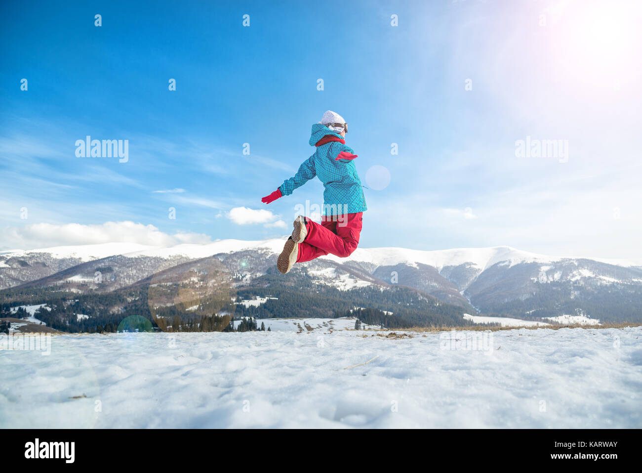 young snowboarder woman jumping over the slope in winter Stock Photo ...