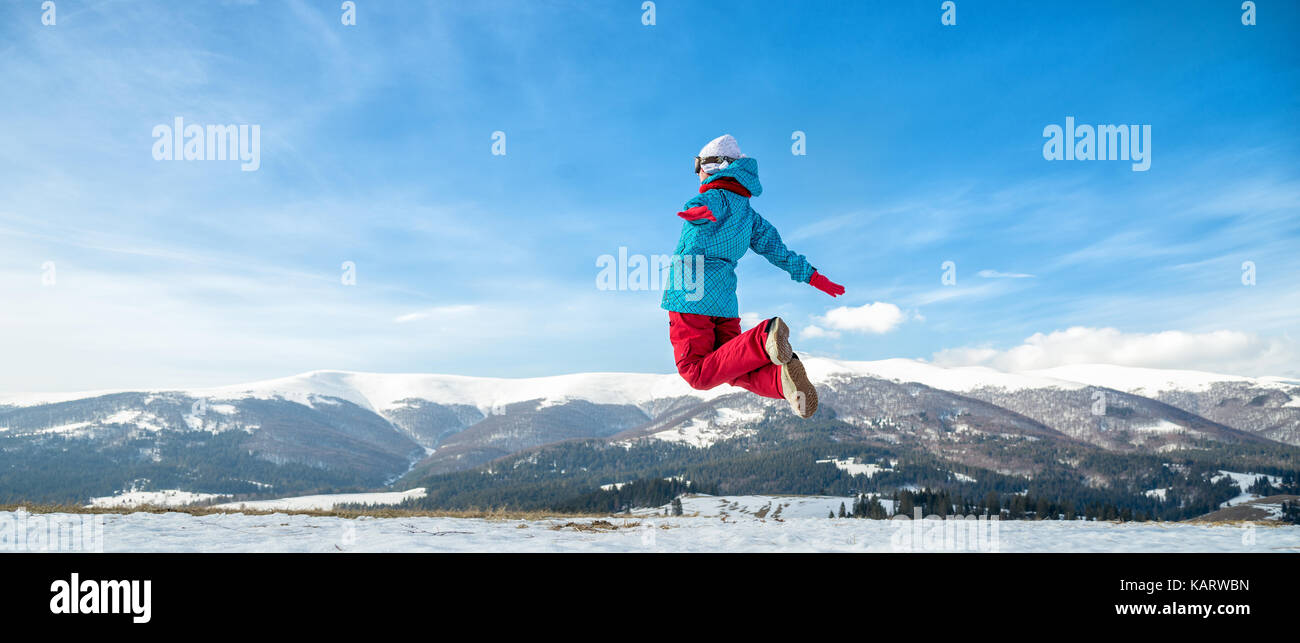 young snowboarder woman jumping over the slope in winter Stock Photo ...