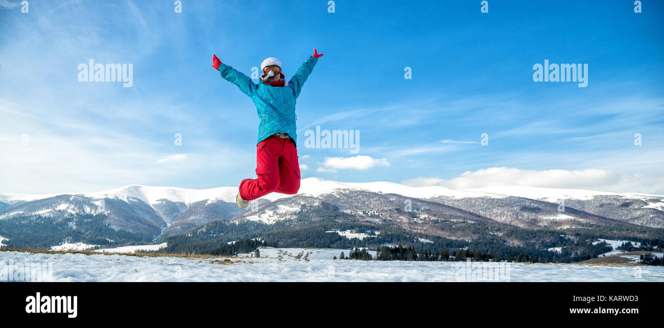 young snowboarder woman jumping over the slope in winter Stock Photo ...