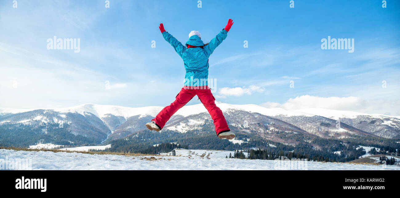 young snowboarder woman jumping over the slope in winter Stock Photo ...
