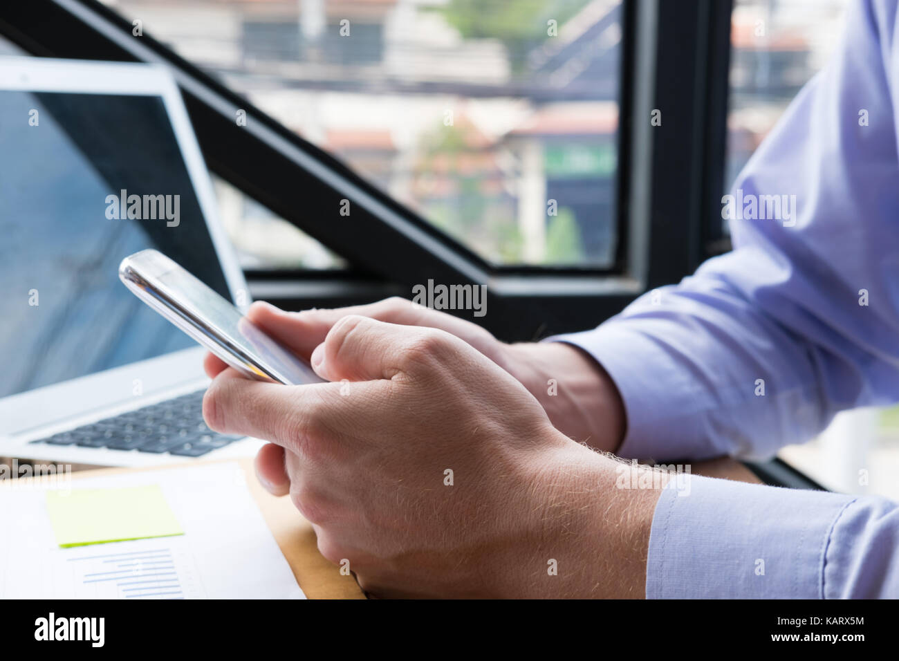 businessman use mobile phone at workplace. young man texting message on ...