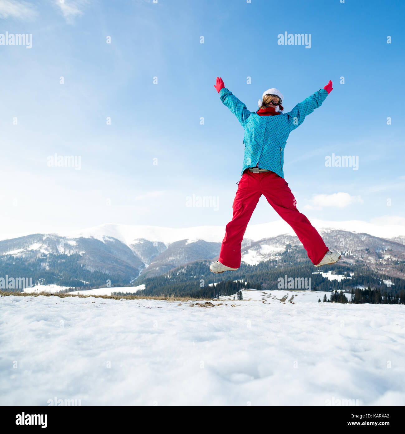 young snowboarder woman jumping over the slope in winter Stock Photo ...