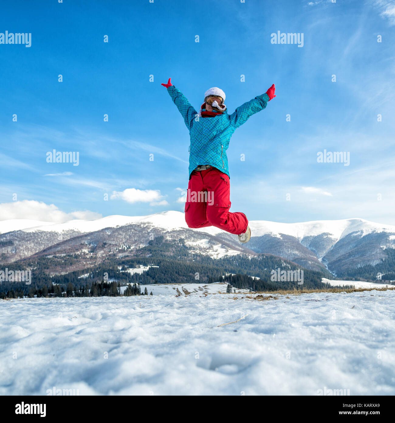 young snowboarder woman jumping over the slope in winter Stock Photo ...