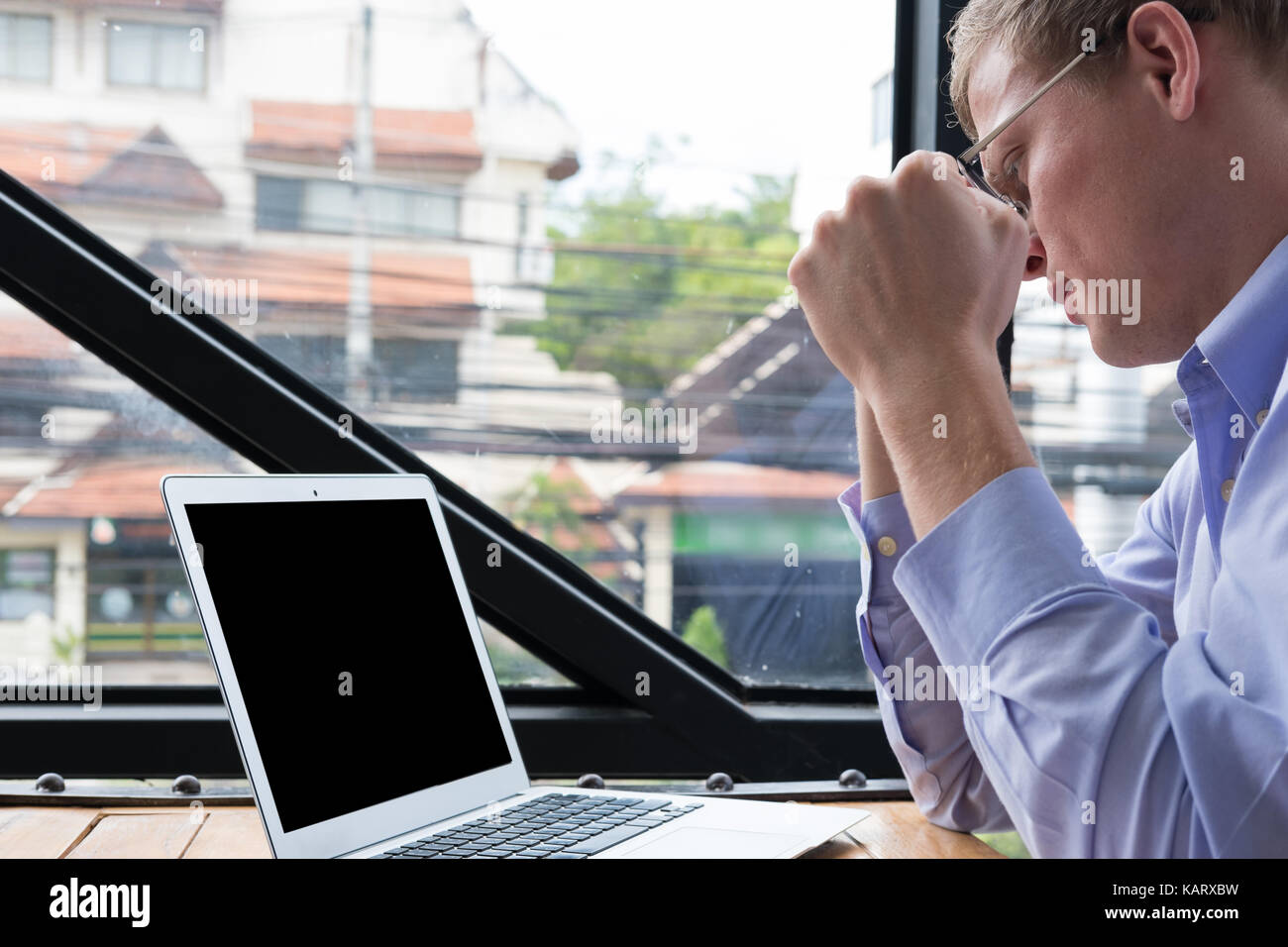 enraged businessman look at laptop. angry young man holding his fists ...
