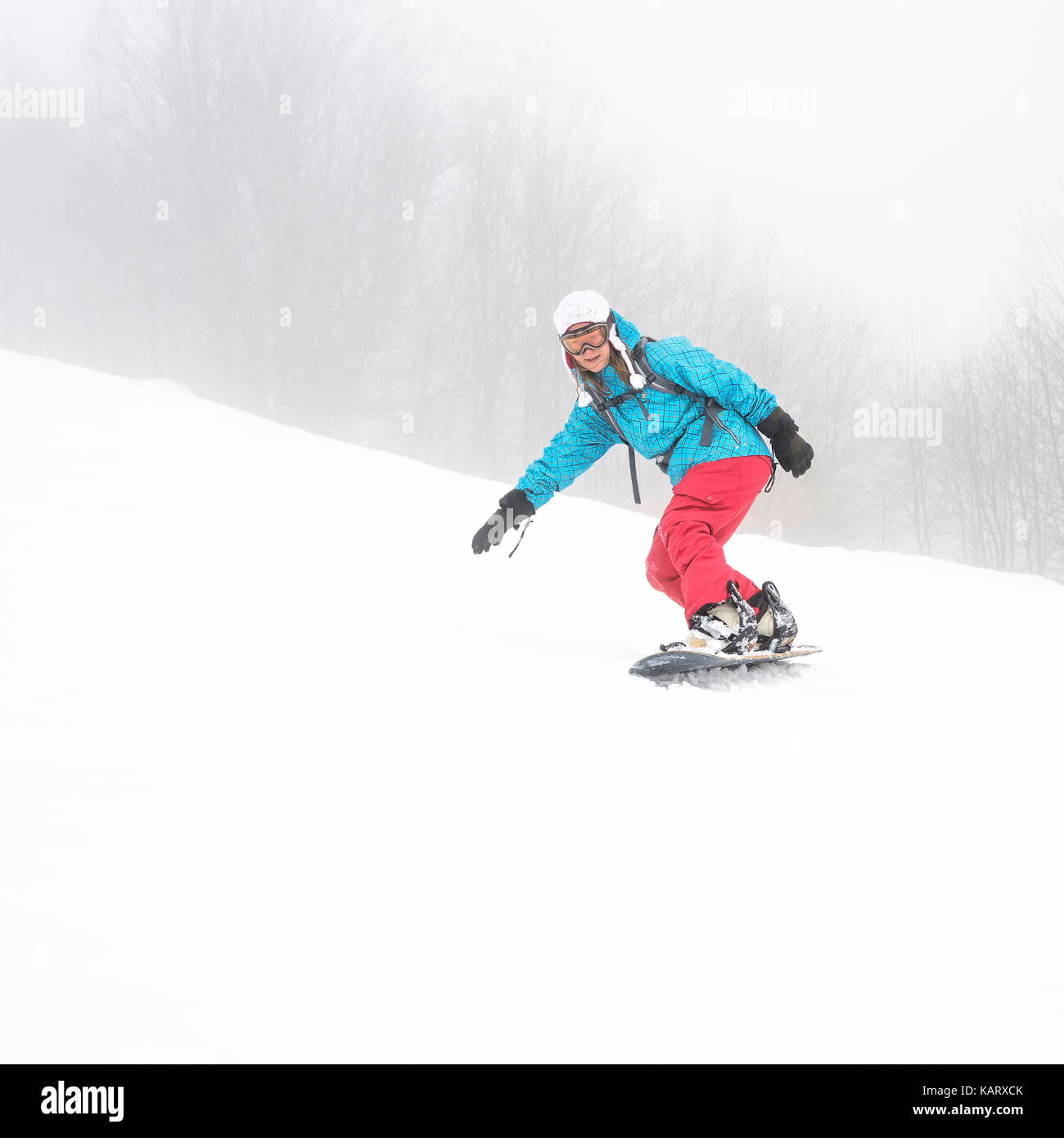 pretty young woman on the snowboard riding in the mountains Stock Photo ...
