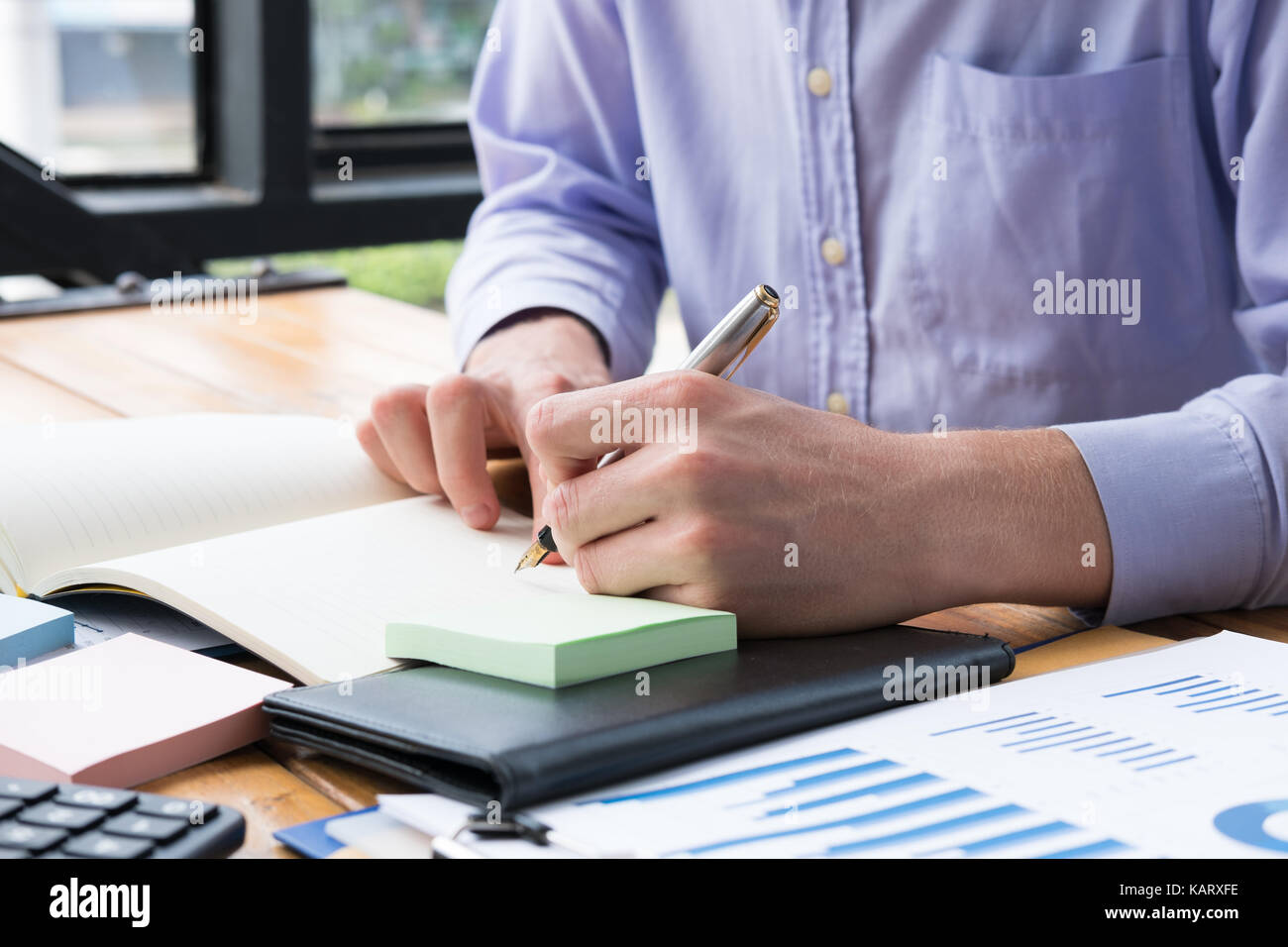 businessman write note on notebook at office desk. young man write memo ...