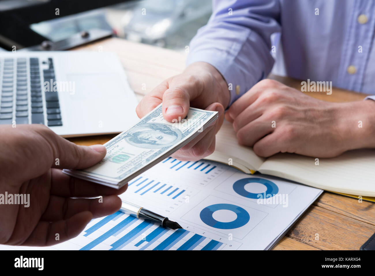 businessman give money. young man offer united states banknote to ...