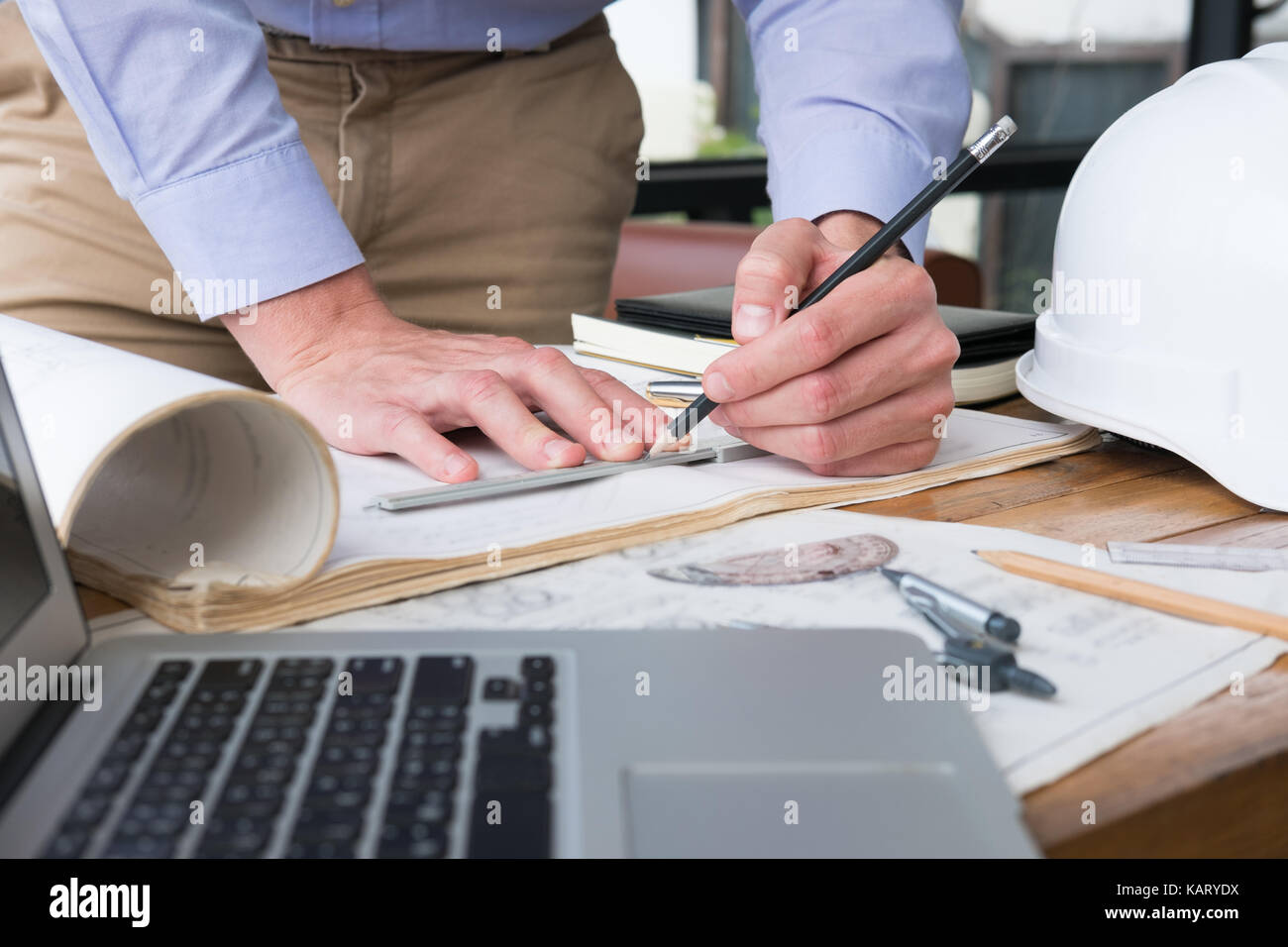 architect hand working on construction plan at office. engineer inspect ...