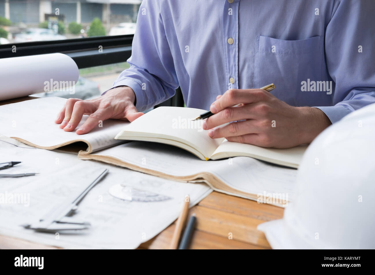 architect working on construction plan at office. engineer inspect ...
