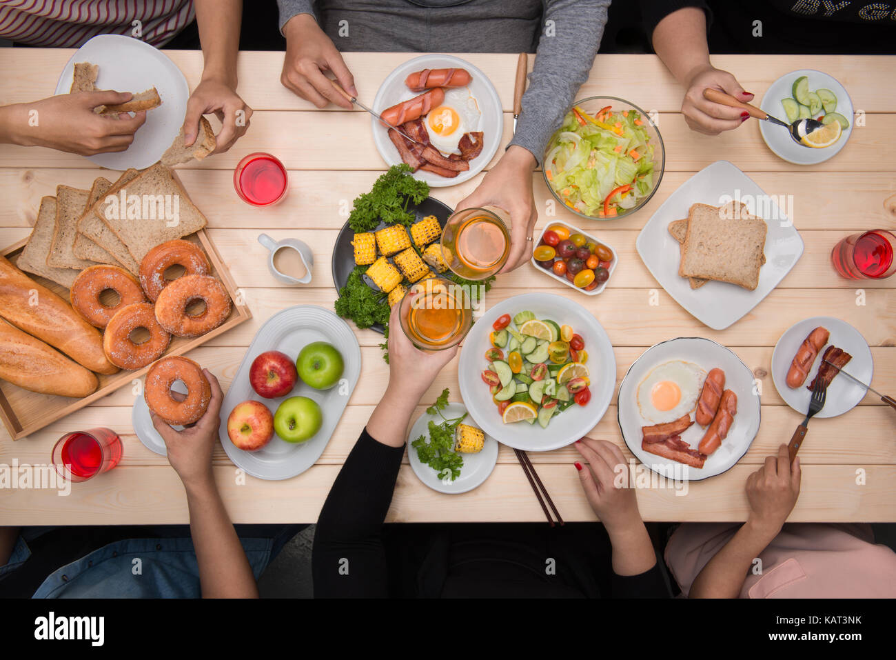 Enjoying dinner with friends. Top view of group of people having dinner ...