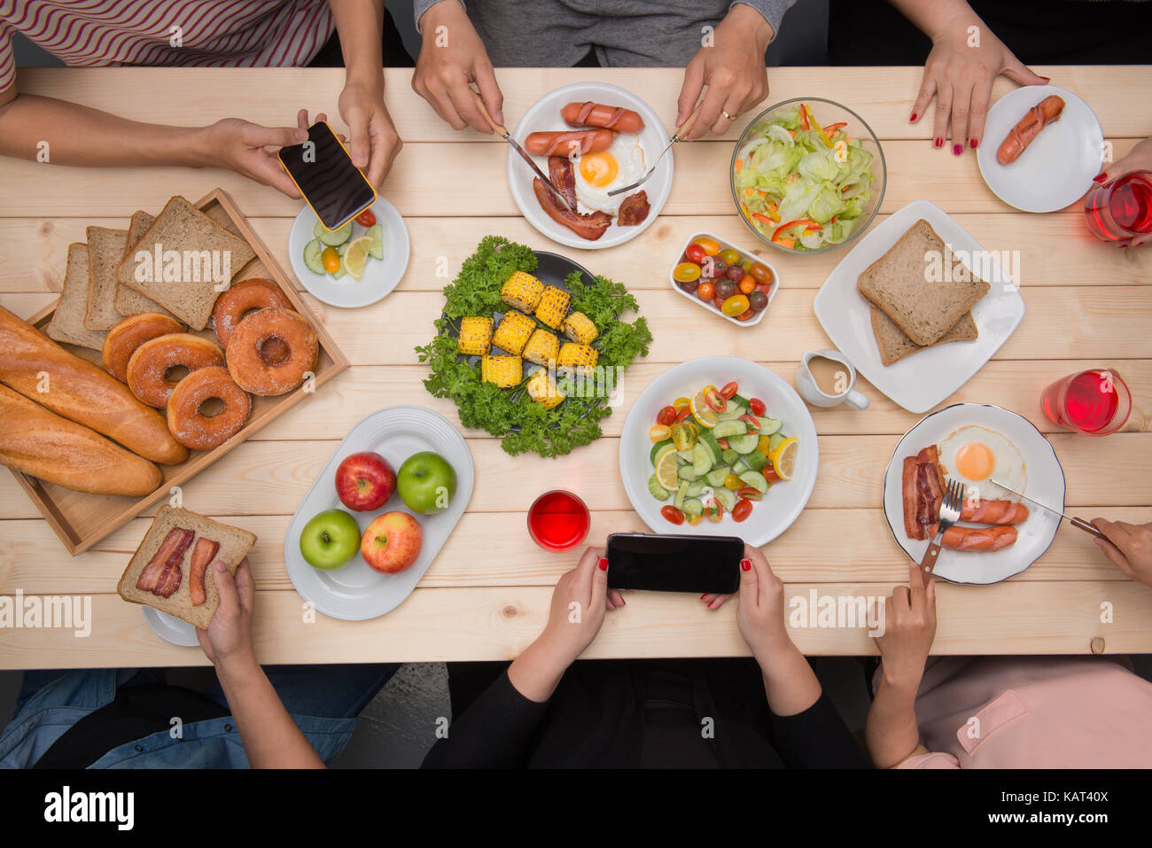 Group of happy smiling friends with smartphones taking picture of food ...