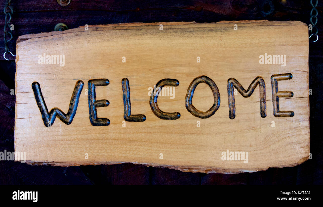 Welcome sign carved in wood Stock Photo - Alamy