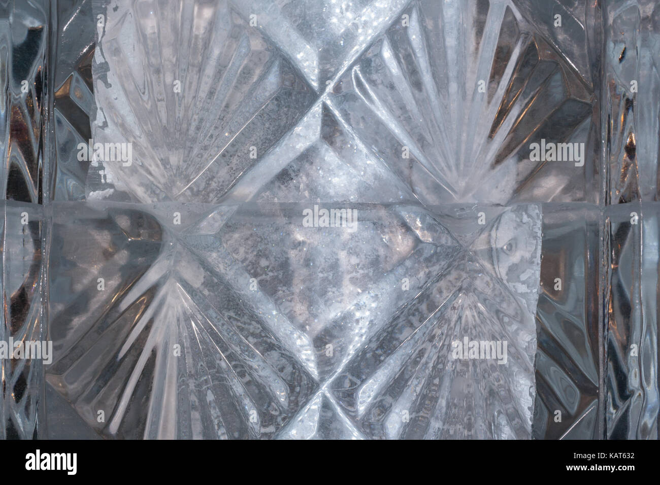 Close-up texture of cube of ice with with beautiful carved pattern ...