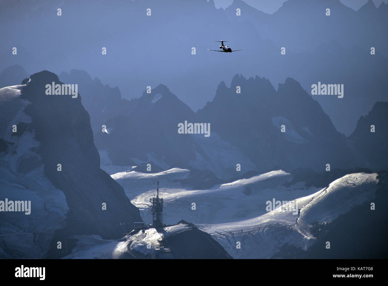 Aerial view of an executive jet low over the Swiss Alps and the Aletsch ...