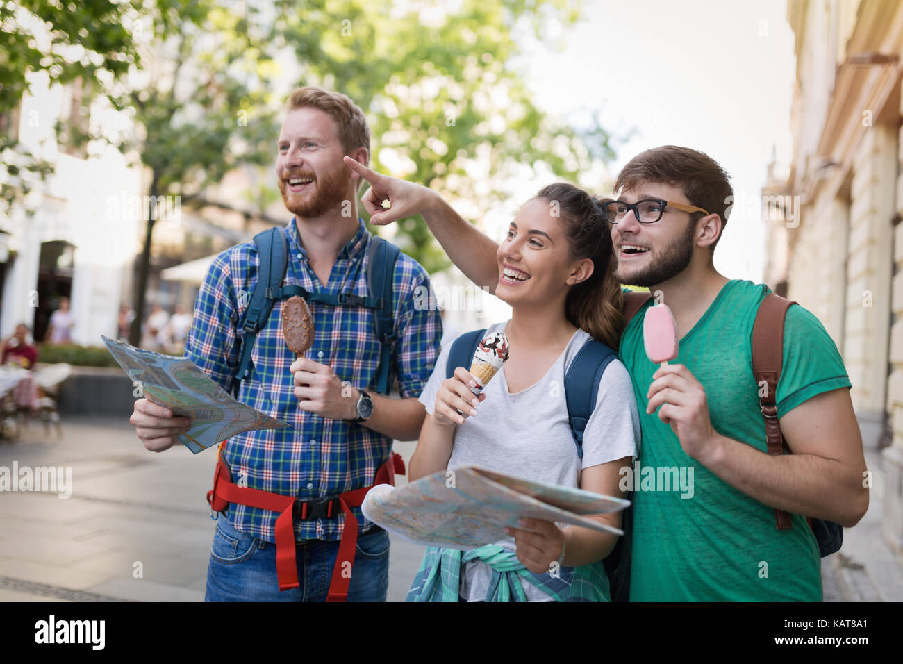 Young happy tourists sightseeing in city Stock Photo - Alamy