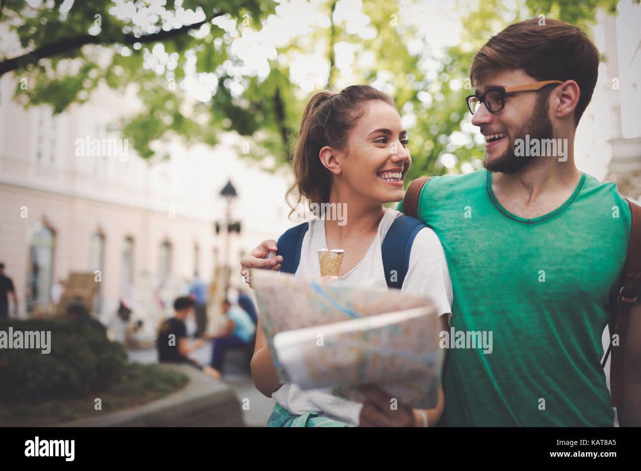 Tourist friends discovering city on foot Stock Photo - Alamy