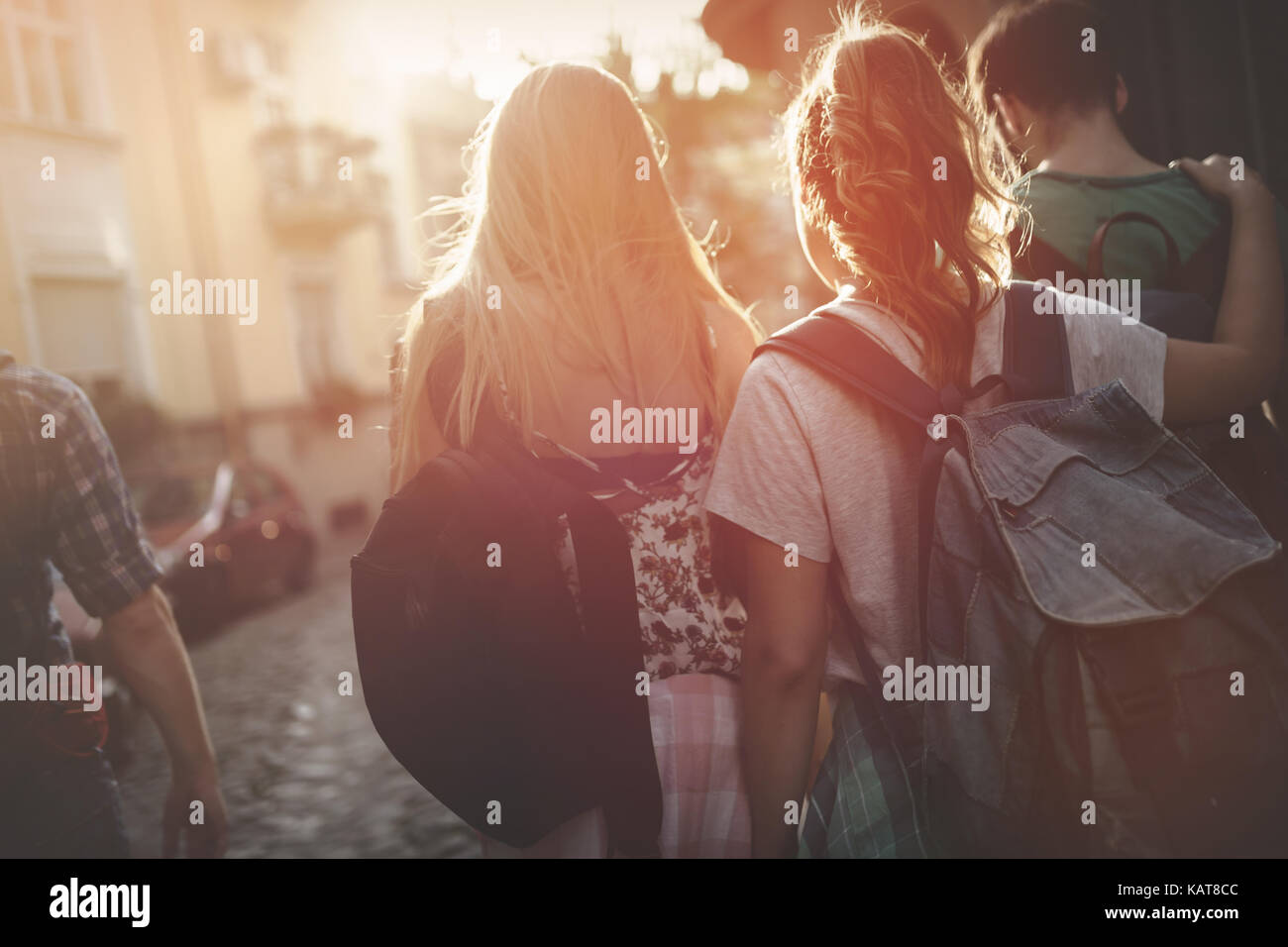 Tourist friends discovering city on foot Stock Photo - Alamy