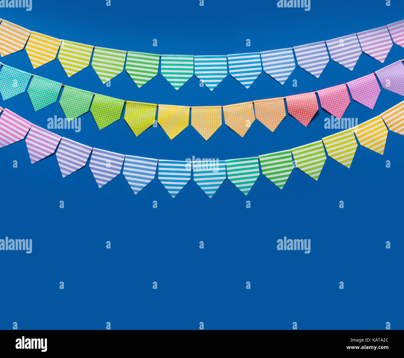 Colored flags garland. The background is blue . celebration Stock Photo ...