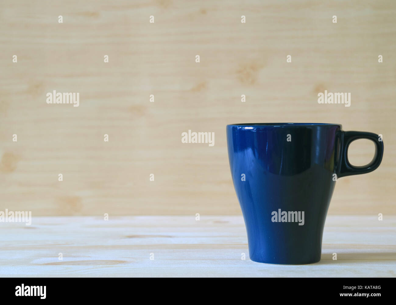 Front view of navy blue mug on the light color wooden table Stock Photo ...