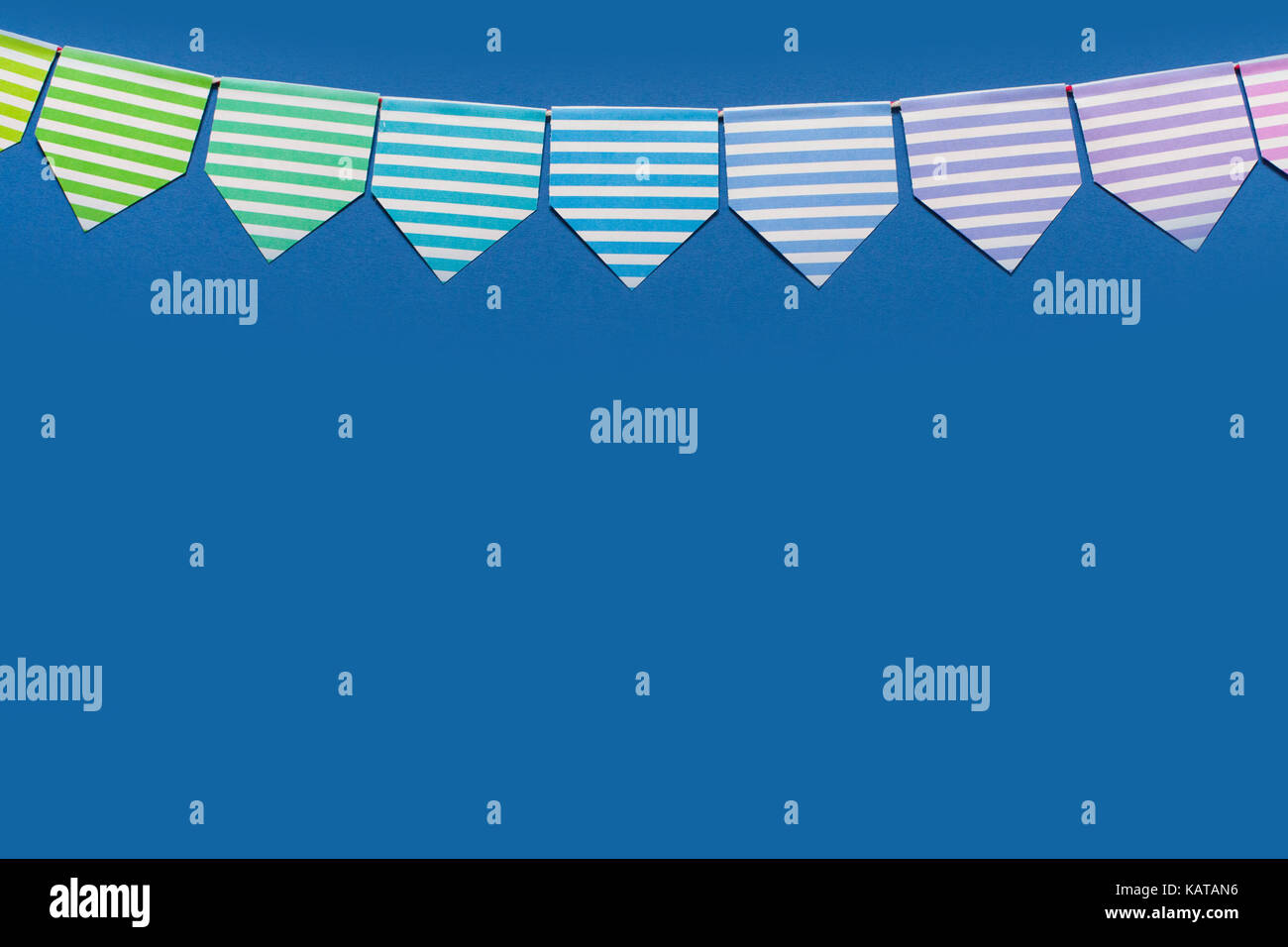 Colored flags garland. The background is blue . celebration Stock Photo ...