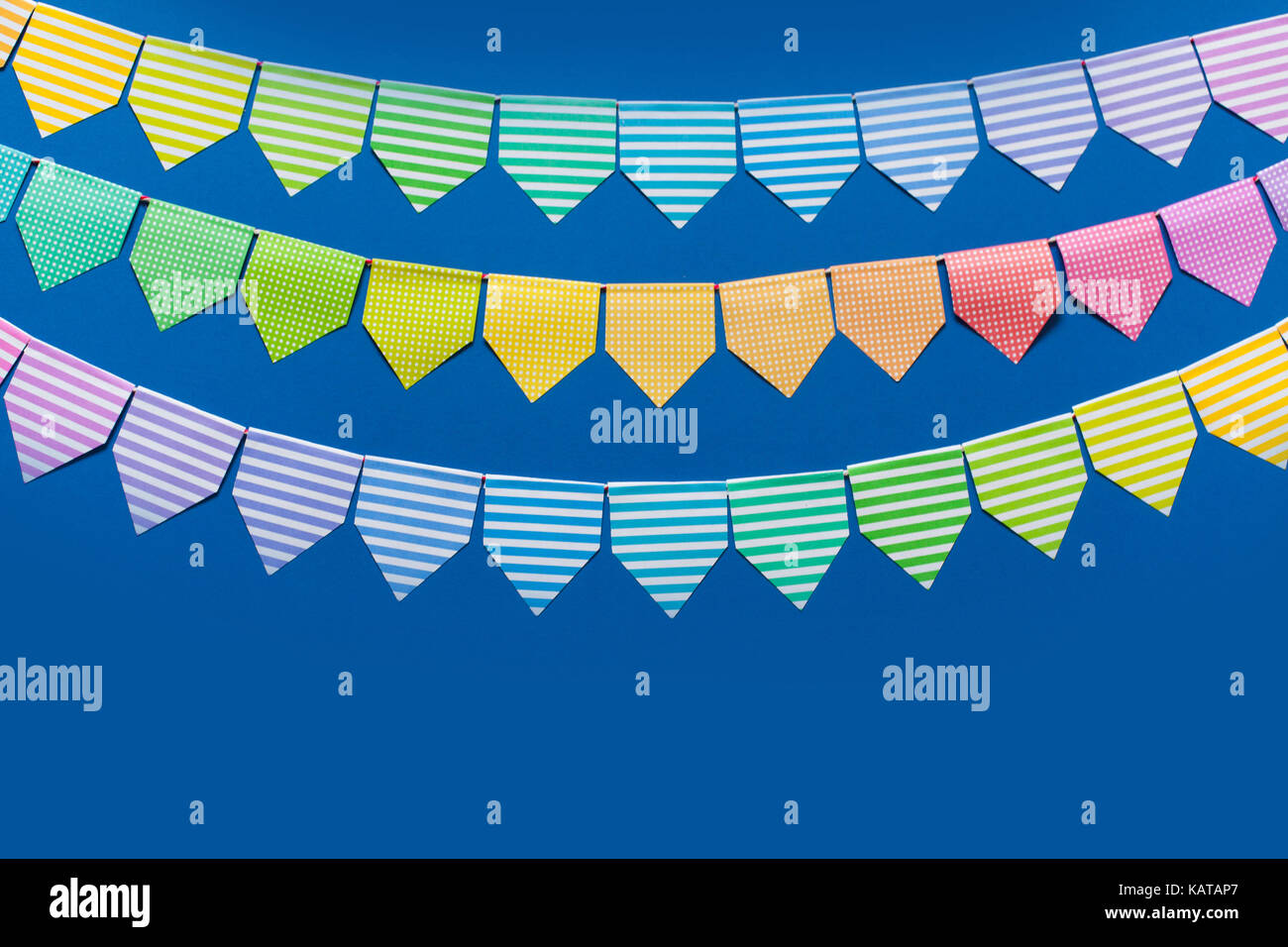 Colored flags garland. The background is blue . celebration Stock Photo ...