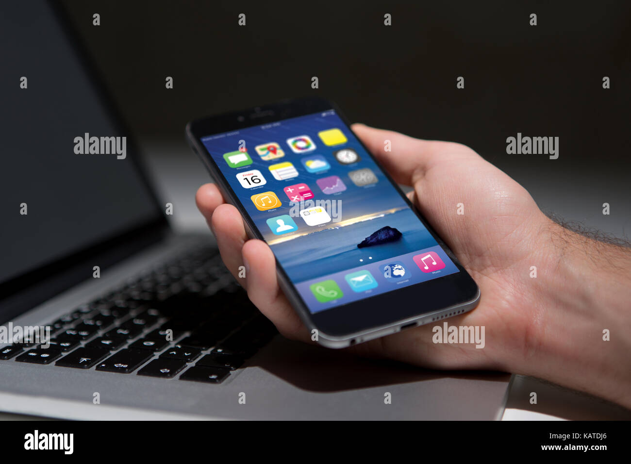 View of a Hand holding black smartphone with operating system screen ...