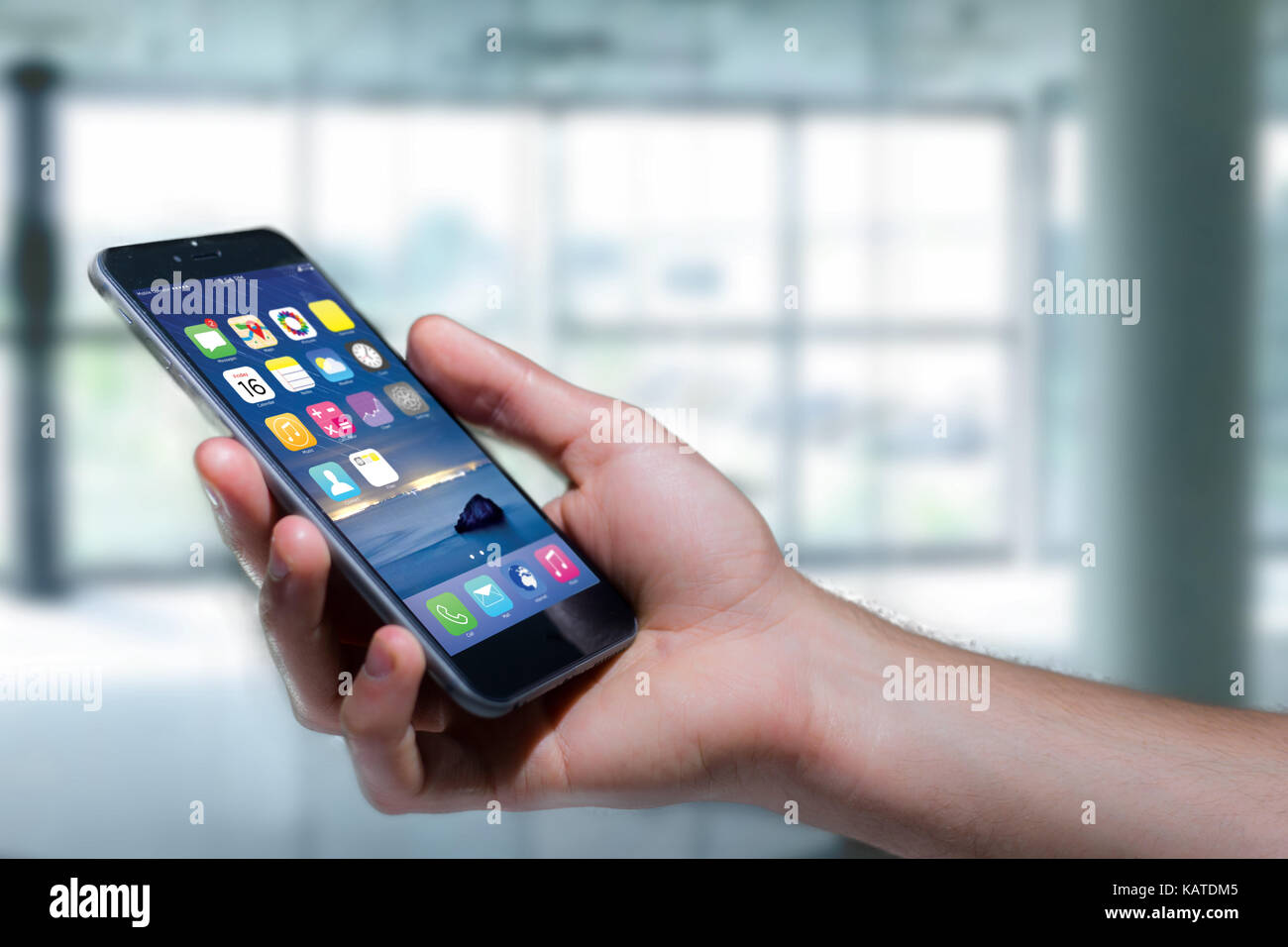 View of a Hand holding black smartphone with operating system screen ...