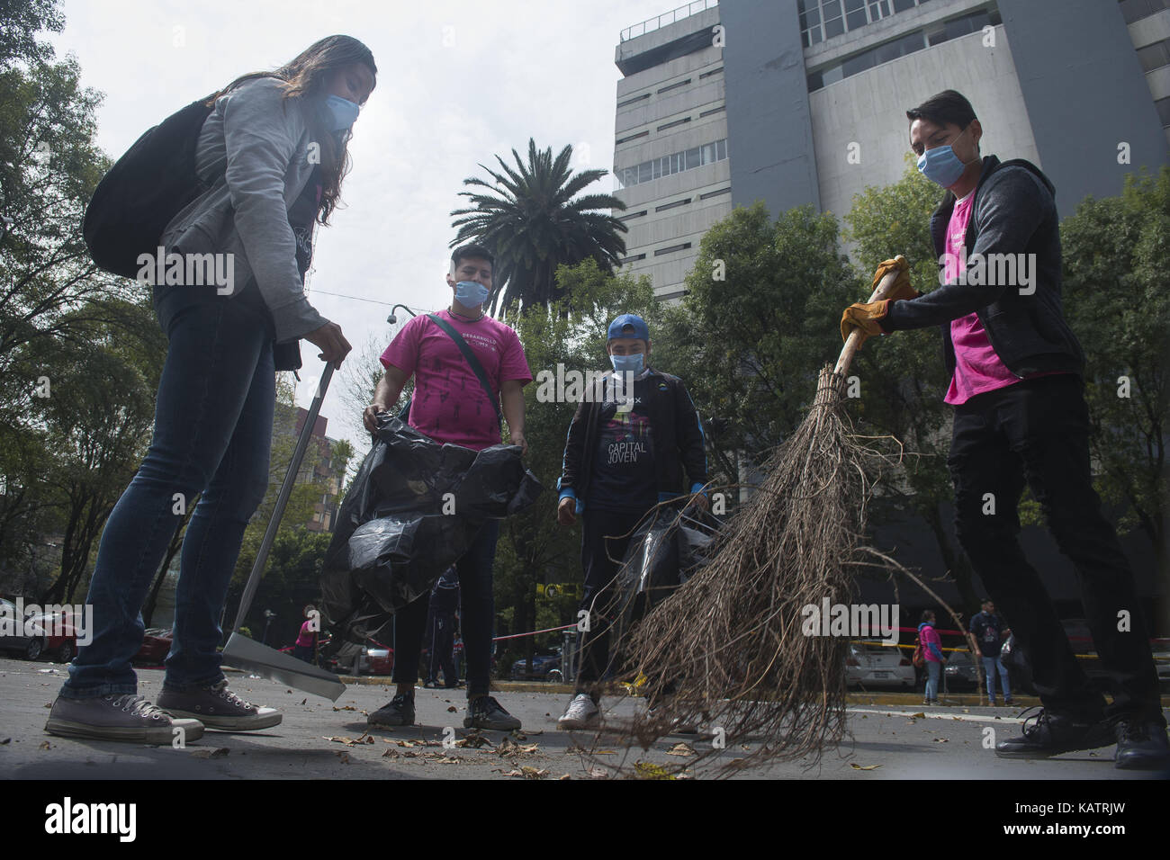 Volunteers help clean up streets in areas affected by the 7.1 ...