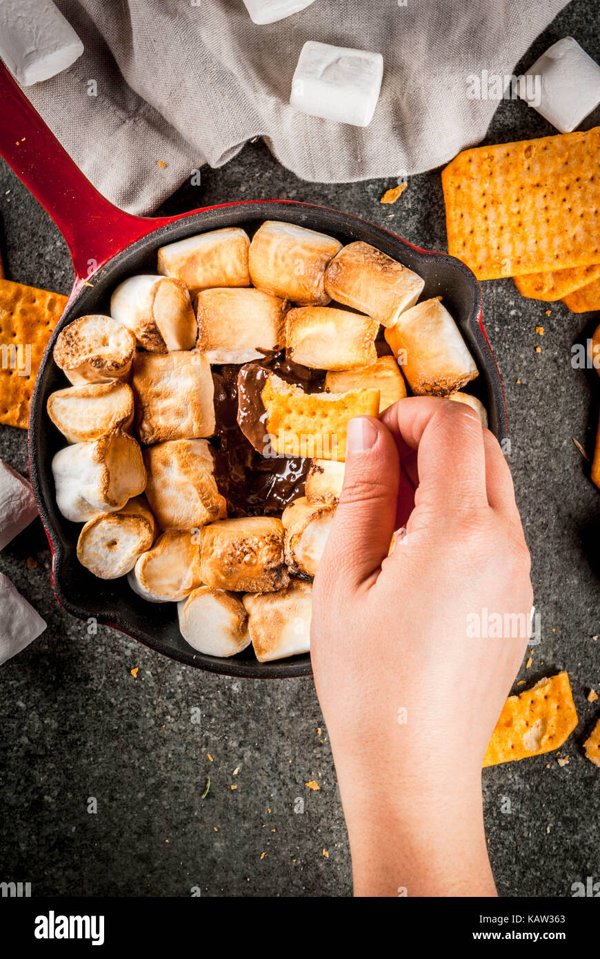Indoor s’mores, baked s’mores dip in a cast iron skillet pan with ...