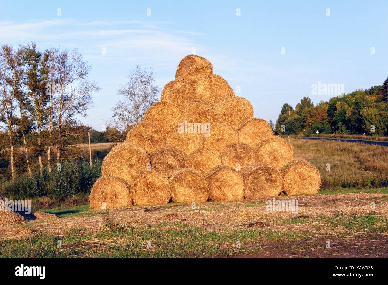 The pyramid is composed of hay balls in the rays of sunset Stock Photo ...