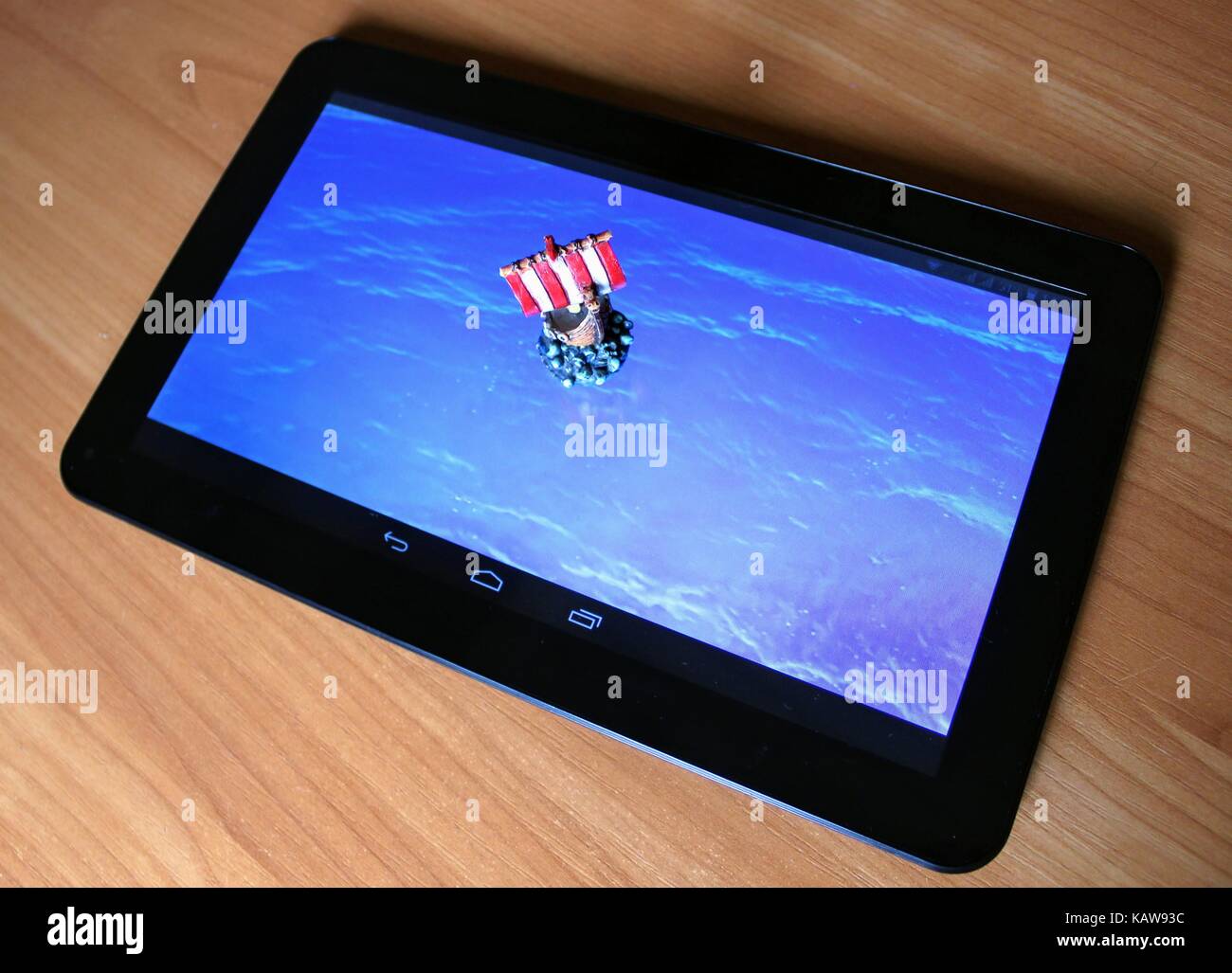 Black tablet on the screen which displays the sea and a souvenir ...