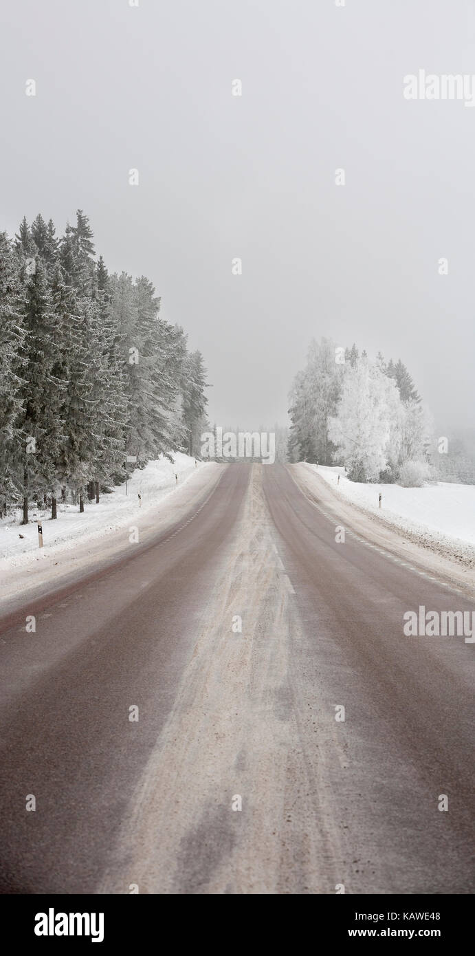 Snowy landscape and winter road in the countryside of Uppland, Sweden ...