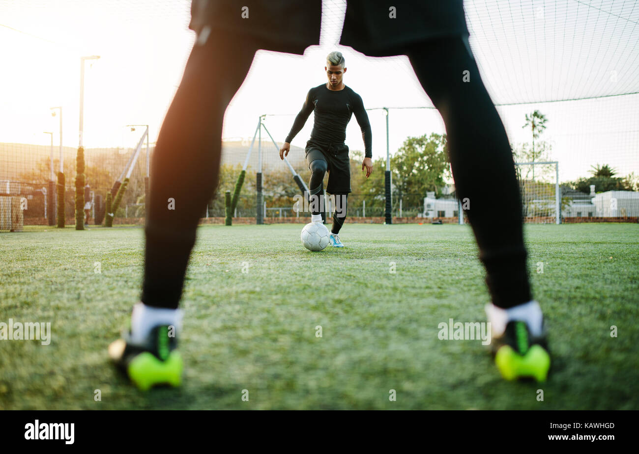Two young football players practicing hi-res stock photography and ...