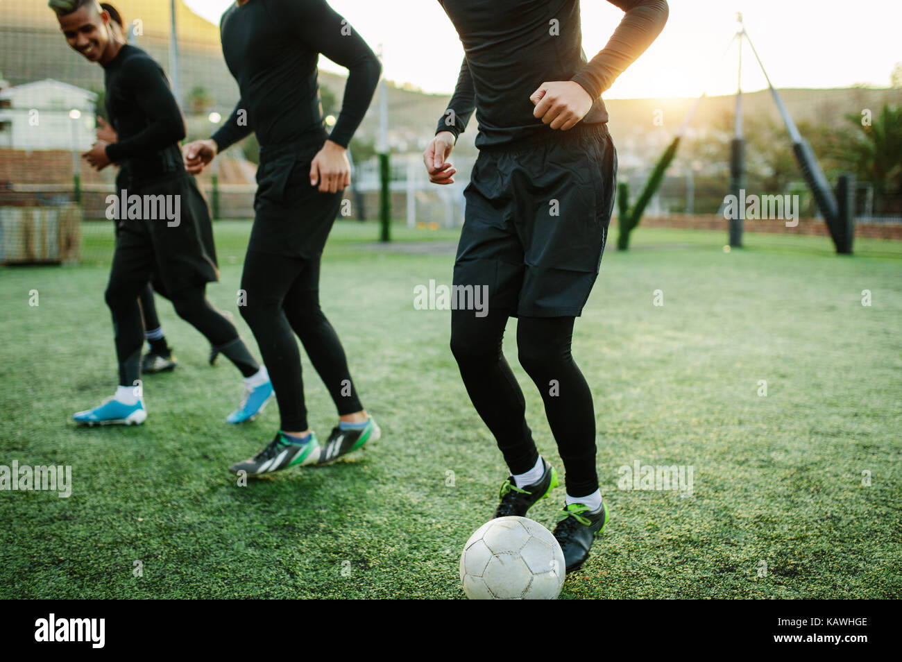 Teenagers playing football on field. Soccer team practicing on football ...