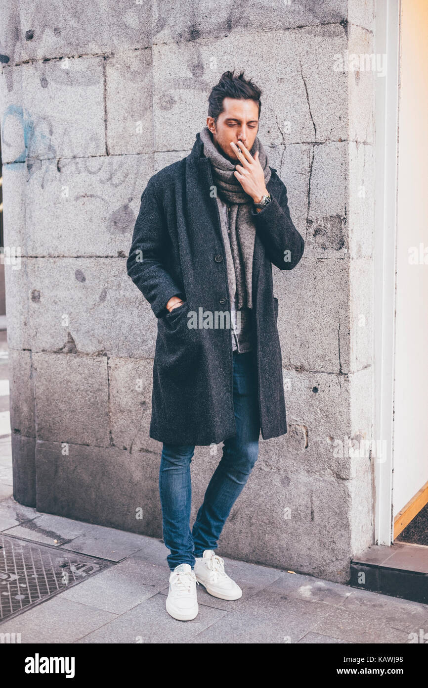 Young man smoking // Street style in Madrid Stock Photo - Alamy