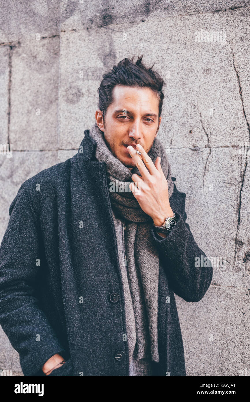 Young man smoking // Street style in Madrid Stock Photo - Alamy