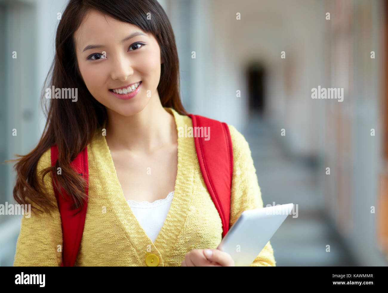 one pretty Chinese asian college student smile at camera in campus ...