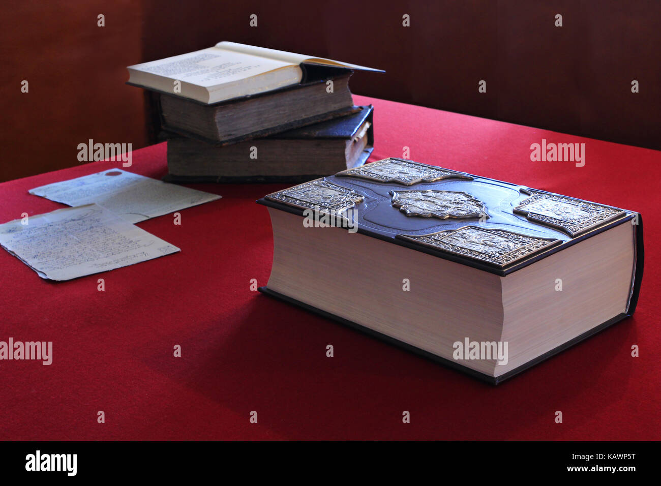 ancient thick books on the vintage red table Stock Photo - Alamy