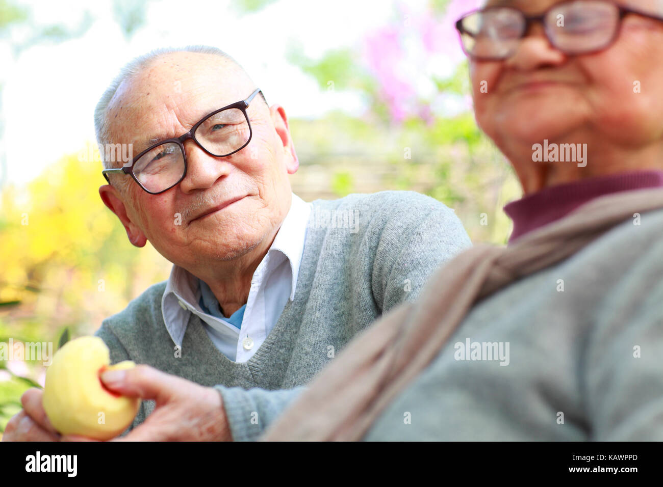 happy senior Chinese couple together in the garden outdoor daily ...